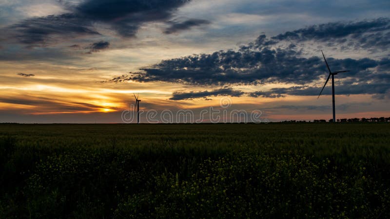 Wind Generator in Grass Field at Sunset Stock Photo - Image of grass ...