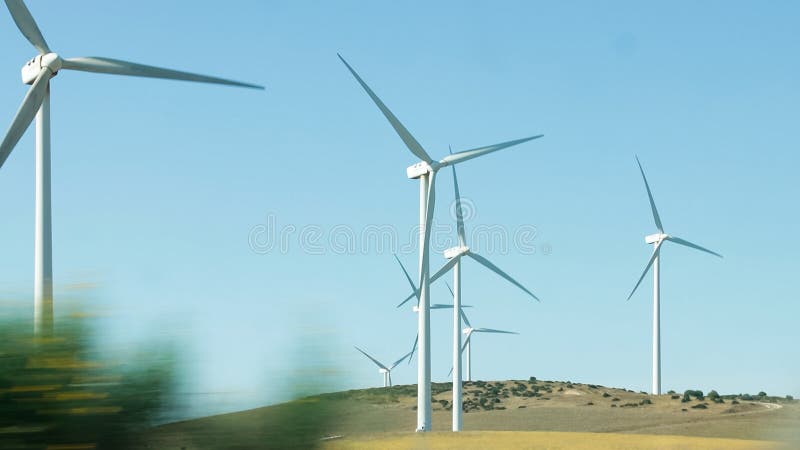 Wind Generators Spinning in Operation Viewed from a Moving Car Stock ...