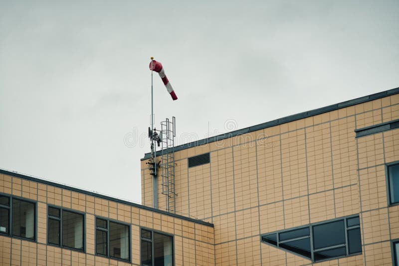 Wind Indicator on the Top of the Building Under a Cloudy Sky. Stock ...