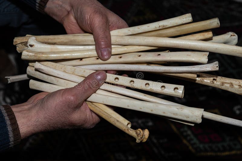 A Wind Instrument Made of Eagle Wing Bones in the Hands of a Man. Stock ...
