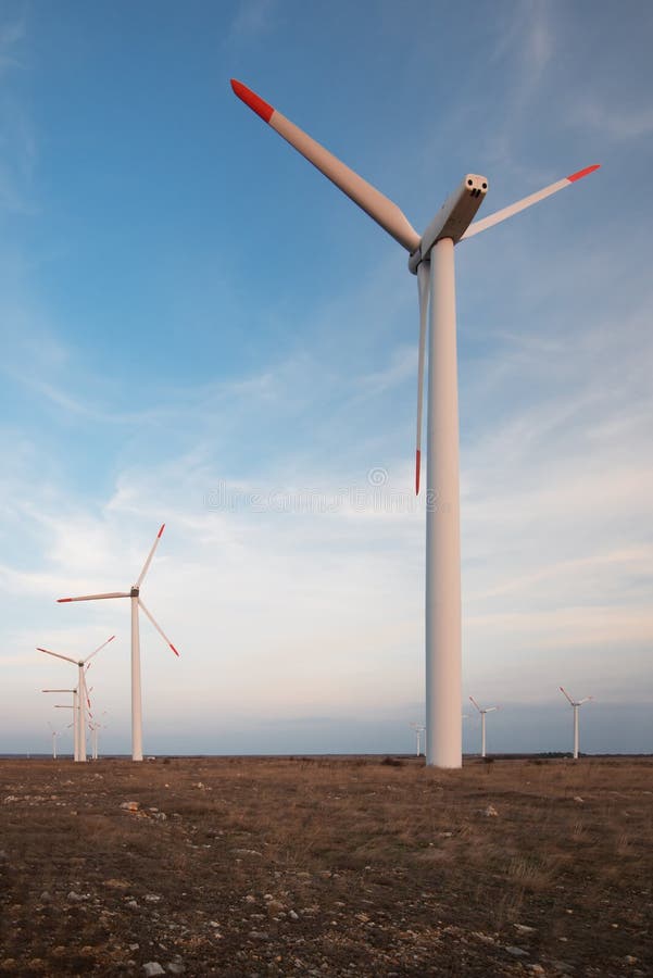 Wind Power Generators at a Windmill Farm in a Plowed Field and a Blue ...