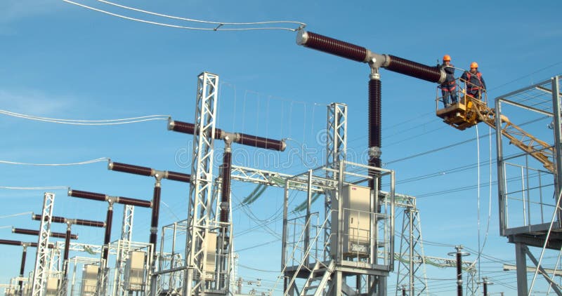 Construction Workers are Working on the High Voltage Power Lines, Wind ...