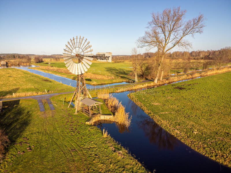 Wind Power Station Windmill on a River in the Middle of Fields and ...