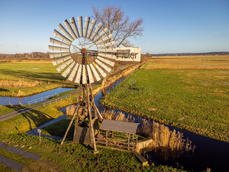 Wind Power Station Windmill on a River in the Middle of Fields and ...