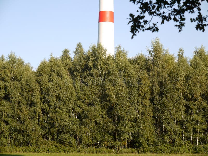 Wind Power Tower in the Forest Surrounded by Green Lush Trees Stock ...