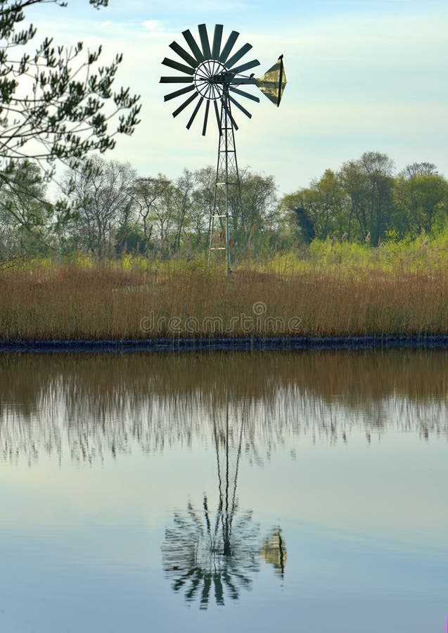 Wind pump by a lake stock image. Image of mill, nature - 374268475