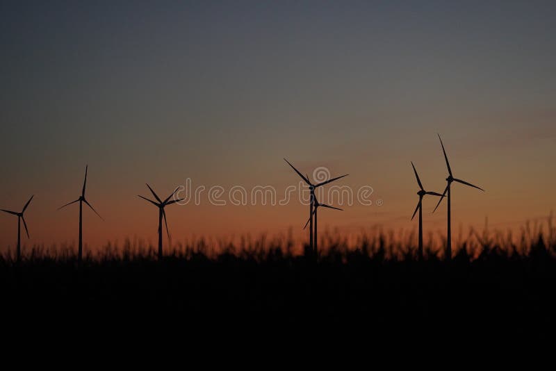 Wind Stations in a Field Against the Backdrop of a Sunset Sky Stock ...