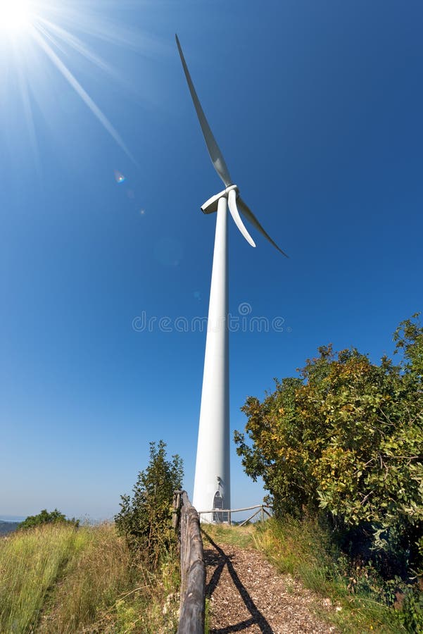Wind Turbine on a Blue Sky with Sun Rays Stock Photo - Image of energy ...