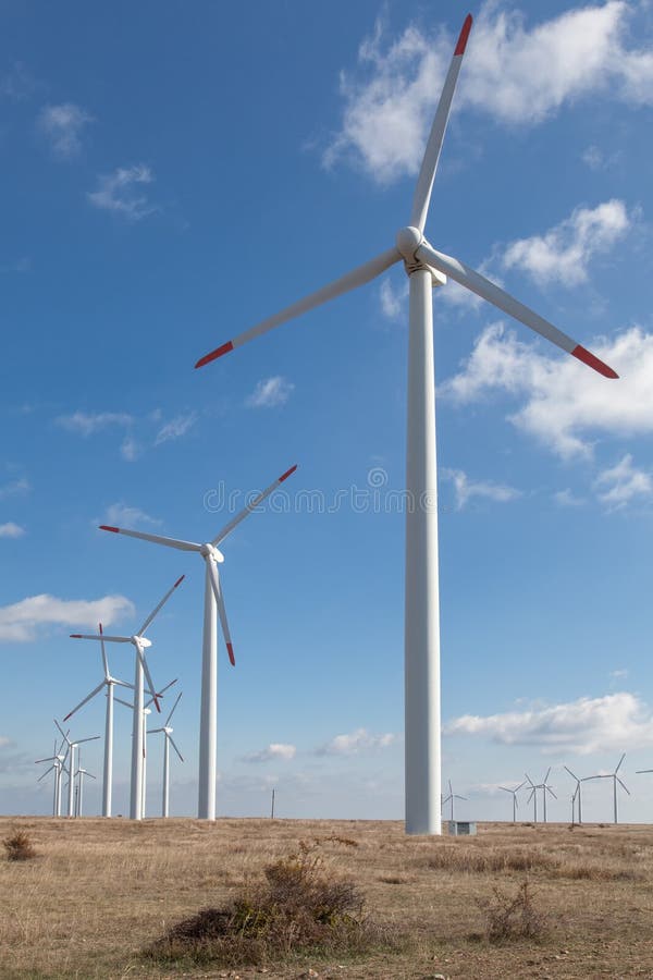 Wind Turbine Farm Over the Blue Clouded Sky Stock Photo - Image of ...