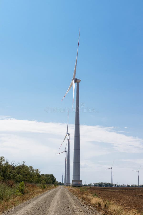 Wind Turbine in a Large Field Above a Blue Overcast Sky Stock Photo ...