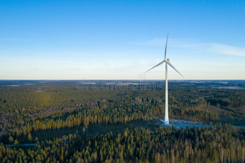 A wind turbine in a forest stock photo. Image of view - 200311662