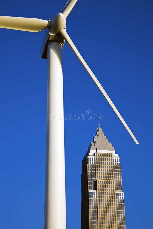 Wind Turbine and Skyscraper Stock Photo - Image of lake, horizontal ...