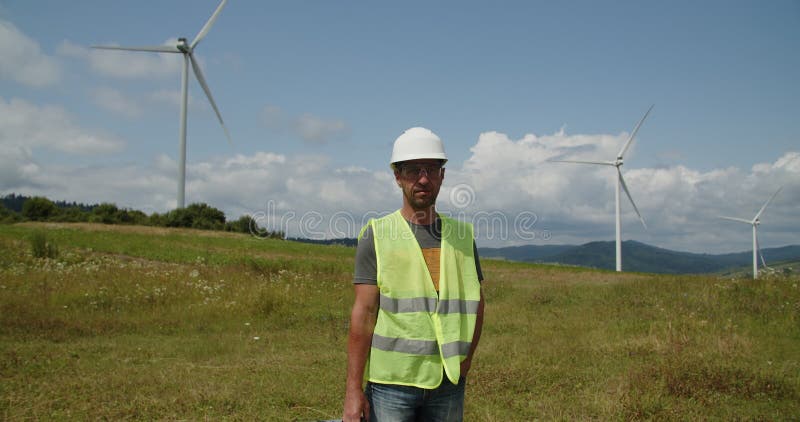 Wind Turbine Specialist Engineer Holding Remote Control. Modern ...