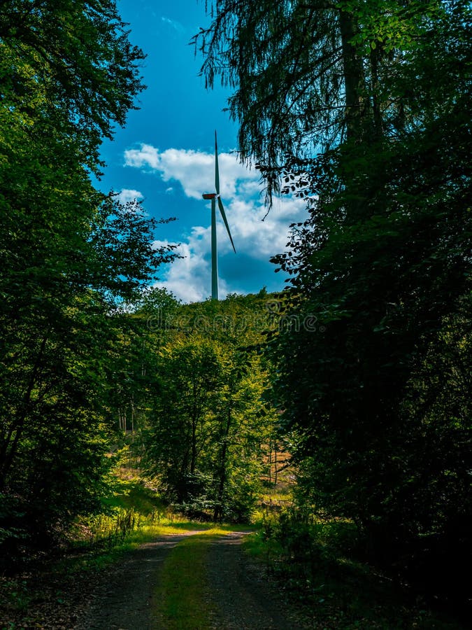 A Wind Turbine Stands in the Forest on a Mountain in Germany Stock ...
