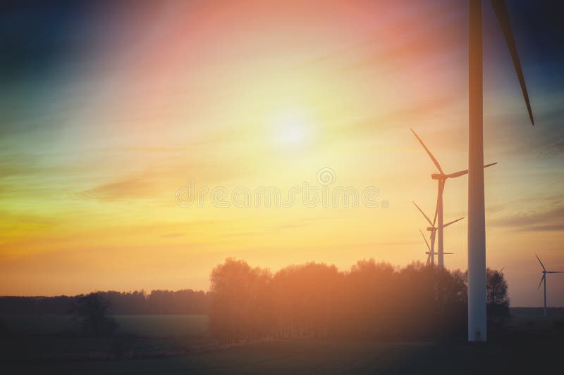 Wind turbine at sunset stock photo. Image of industrial - 69275298