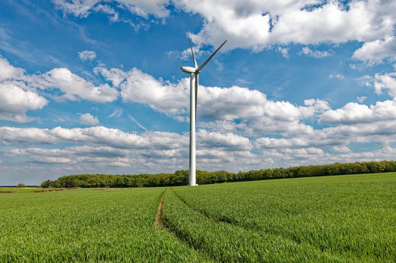 Wind Turbine in a Vast Green Field Stock Photo - Image of scenery ...