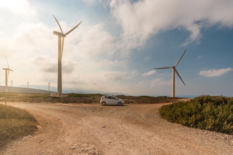 Wind Turbines with a Car on a Sunny Day. Green Energy Generation ...