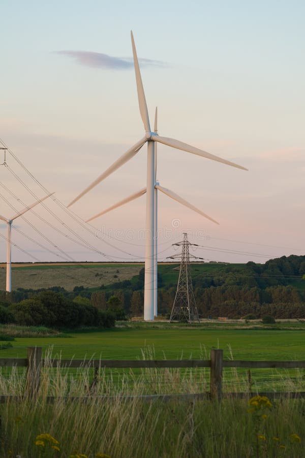 Wind Turbines and Electricity Pylons Stock Photo - Image of wind, green ...