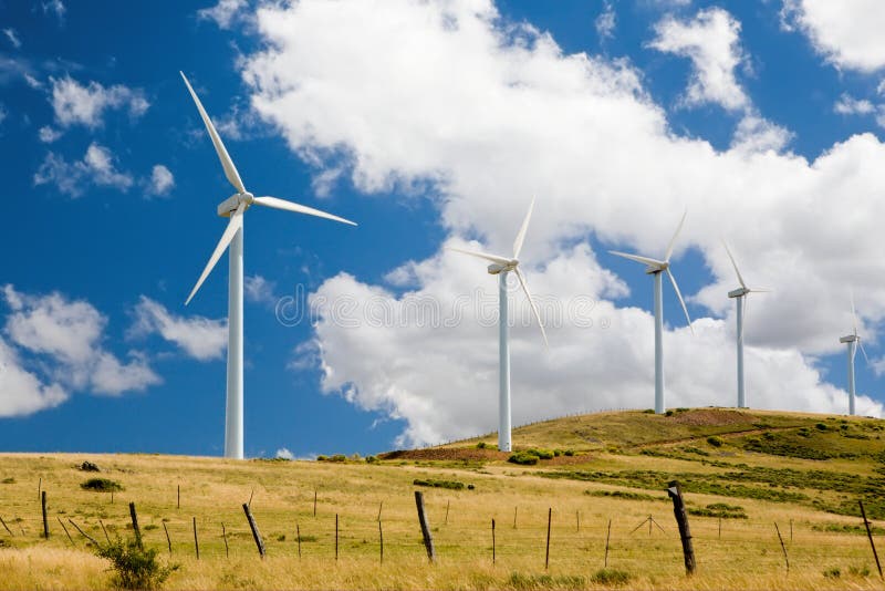 Wind Turbines in a Field stock photo. Image of fence, sustainability ...