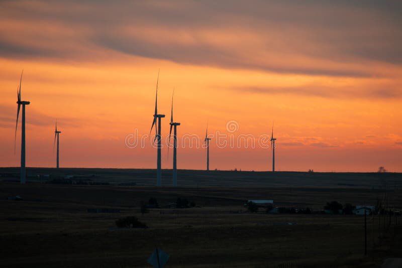 Wind Turbines in a Field at Sunset Stock Photo - Image of color, sunset ...