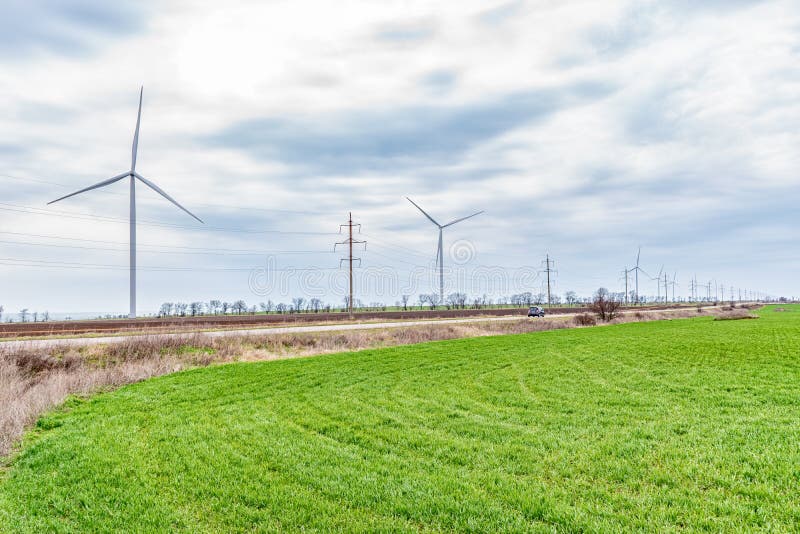 Wind Turbines Generating Electricity in a Green Field. Green Power ...