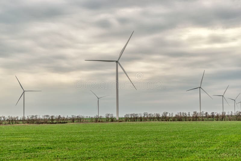 Wind Turbines Generating Electricity in a Green Field. Green Power ...