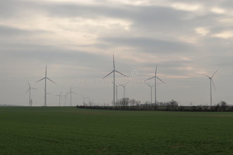 Wind Turbines in the Middle of Fields. Cloudy Sky. Wind Farm Stock ...