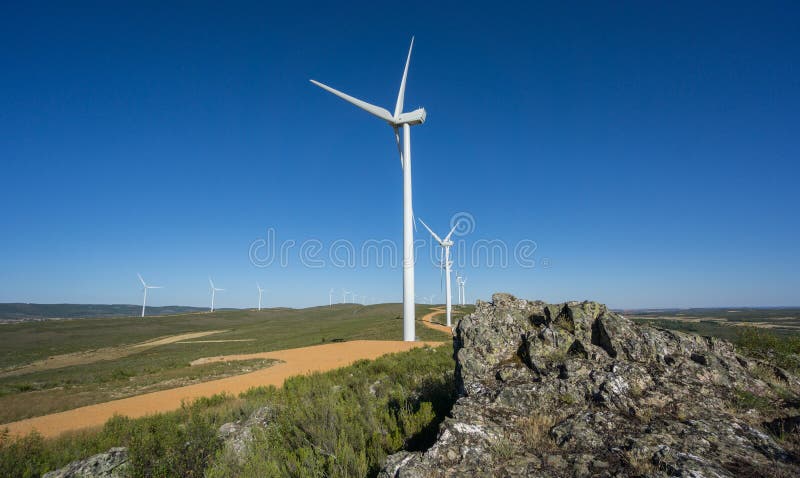 Wind Turbines, Track and Rocks in the Countryside Stock Photo - Image ...