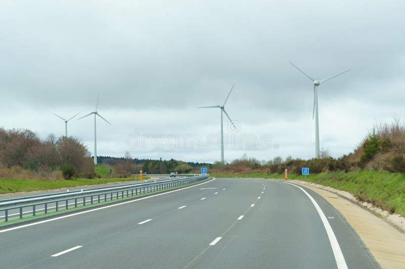 Wind Turbines of a Wind Farm Standing Along the Road. Stock Image ...