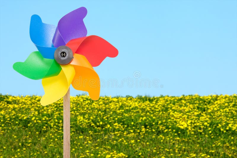 Wind Wheel in Front of Summer Meadow Stock Photo - Image of color ...