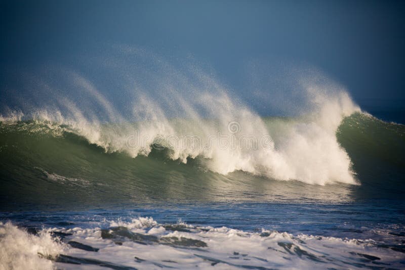 Wind Whipped Spray Rises Highabovef the Waves Rolling into Shore Stock ...