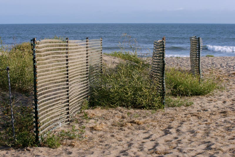 Windbreaker Fences are Seen at the Beach. Stock Image - Image of ...