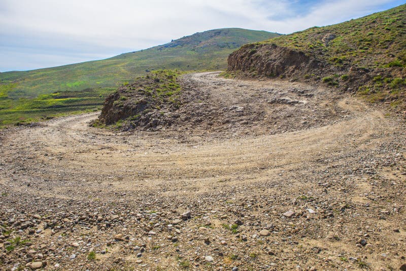 Winding dirt, rocky road stock image. Image of green - 149928047