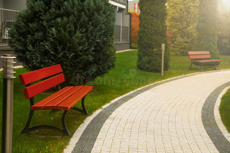Winding Pathway with Beautiful Bushes and Benches in Park Stock Photo ...