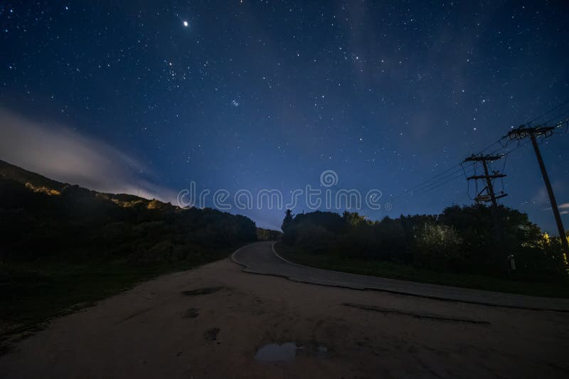 A Winding Road at Night Under a Starry Sky Stock Photo - Image of ...
