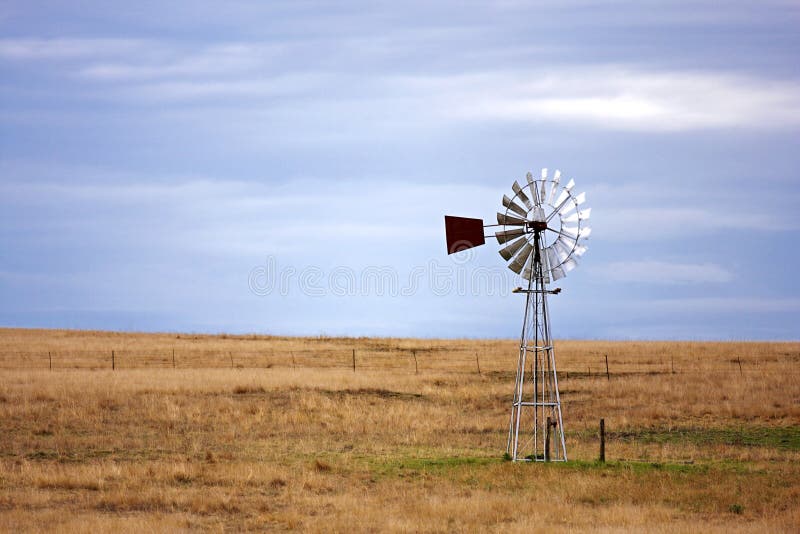Windmill on Great Plains stock photo. Image of clouds - 5291668
