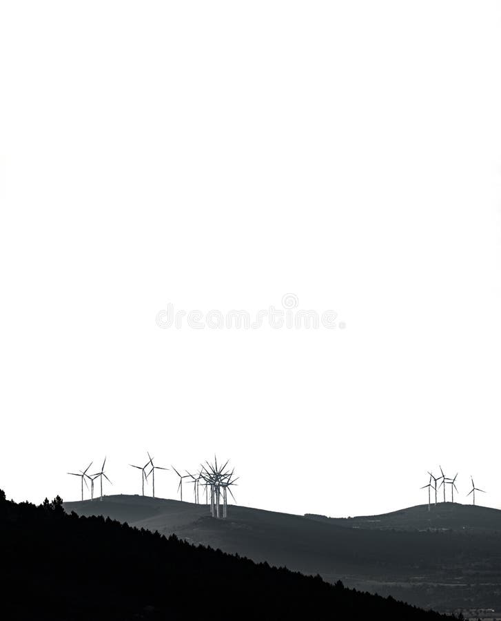 Windmill Array Over the Mountain Range Against White Sky Stock Image ...