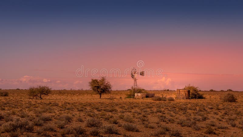 Windmill in a Breathtaking Landscape at Sunset in the Kalahari Desert ...