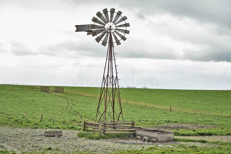 Windmill on Great Plains stock photo. Image of clouds - 5291668