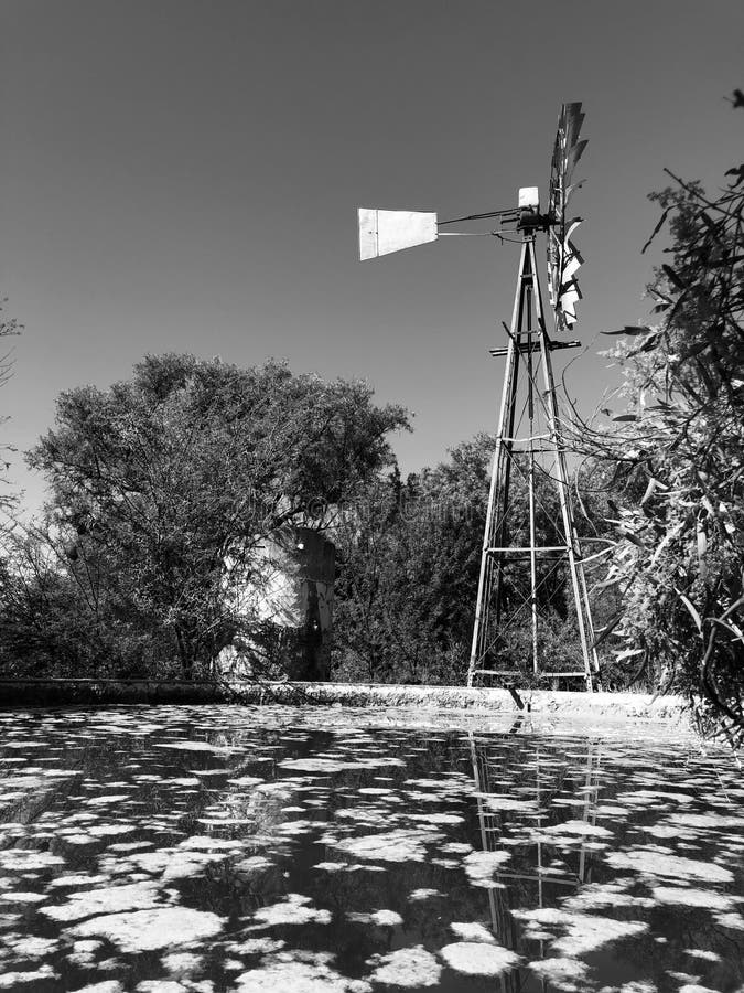 The windmill and the dam stock image. Image of windmill - 255773115