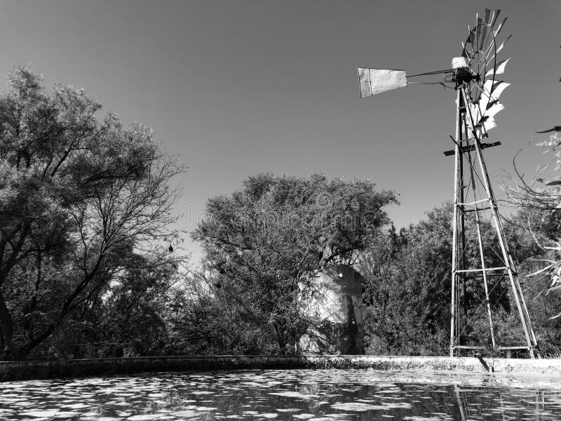 The windmill and the dam stock image. Image of wind - 255773137