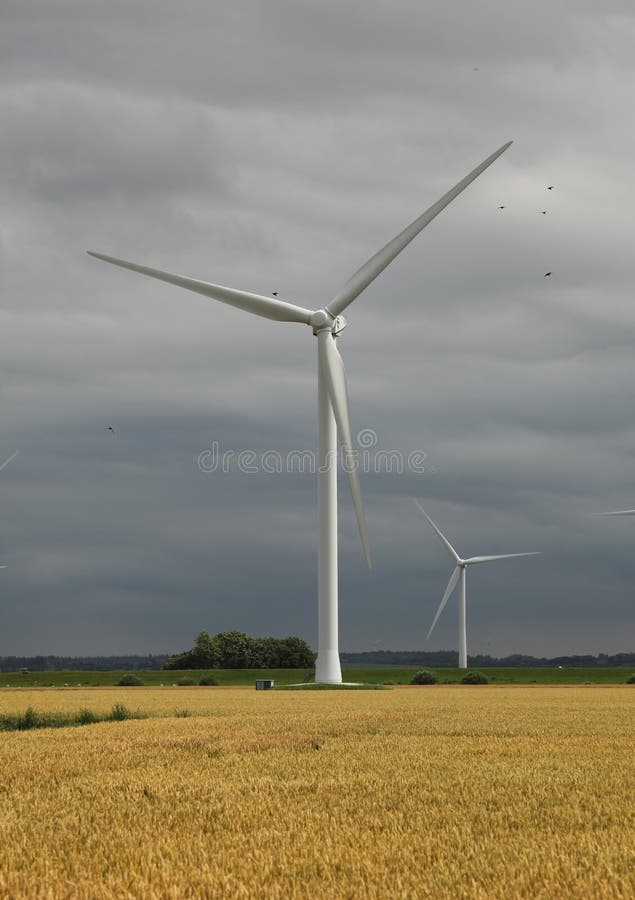 A Windmill in Front of a Cloudy Sky Stock Photo - Image of ...