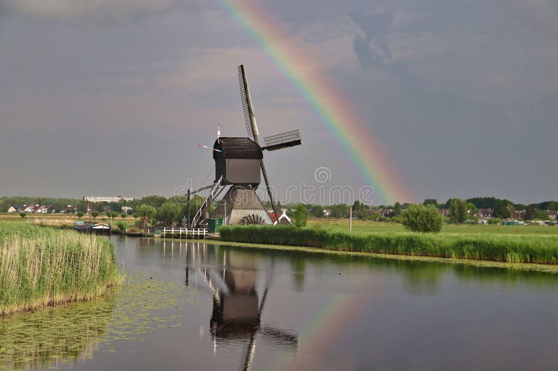 Windmill in Front of a River in Farmland Under the Beautiful Rainbow ...
