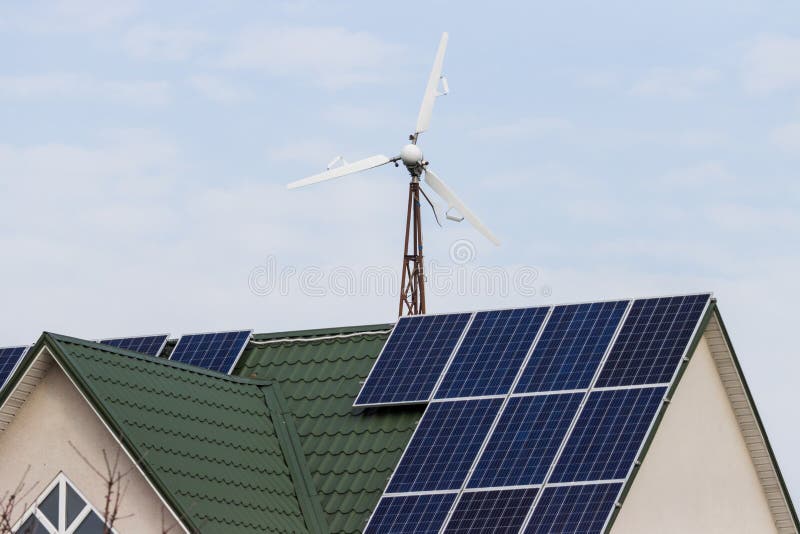 Windmill And Home With Solar Panels Stock Photo - Image of ...
