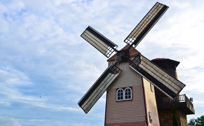 A Windmill with House in Holland Under a Dramatic Sky Stock Photo ...