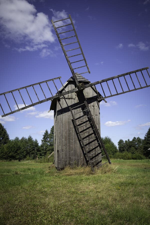 A Windmill with a Ladder on Top of it Stock Photo - Image of rustic ...