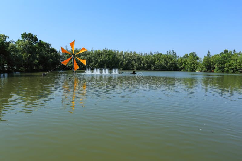 Windmill and lake stock image. Image of aeration, pond - 114347269