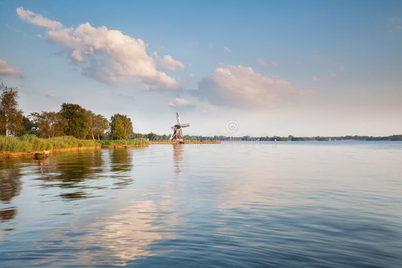 Windmill and lake stock image. Image of aeration, pond - 114347269