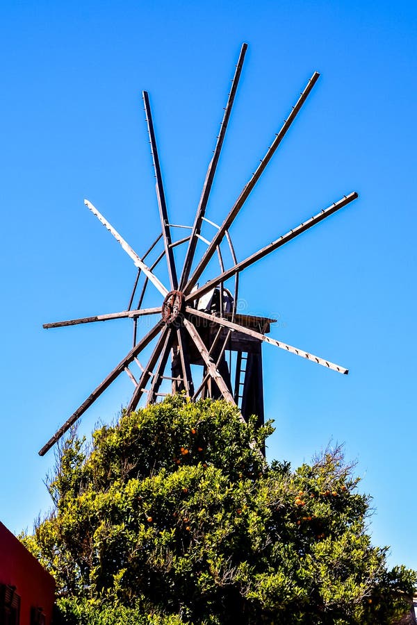A Windmill with a Large Wooden Wheel is on Top of a Tree Stock Image ...