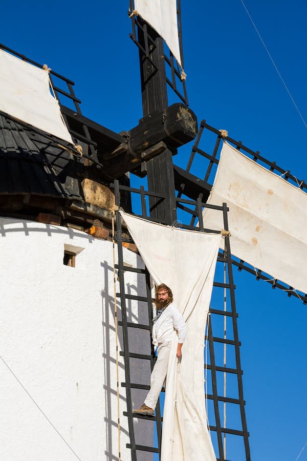 Windmill with Man Climbing on the Blades To Install the Tarp To Make it ...